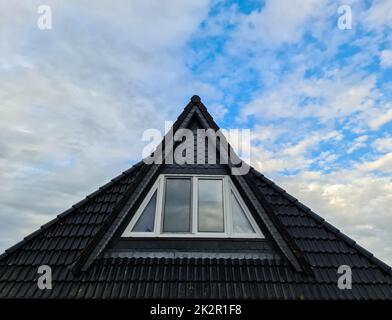 Open roof window in velux style with black roof tiles Stock Photo - Alamy