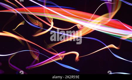 Colorful strings in motion against black background Stock Photo - Alamy