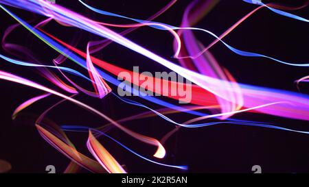 Colorful strings in motion against black background Stock Photo - Alamy