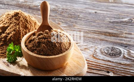 Composition with a bowl of ground coriander Stock Photo - Alamy