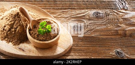 Composition with a bowl of ground coriander Stock Photo - Alamy