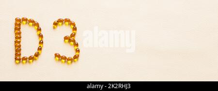Bright oil yellow pills forming shape D3. Vitamin D3 capsules. Medicine ...