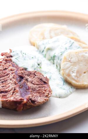 beef meat with dill sauce and dumplings Stock Photo - Alamy