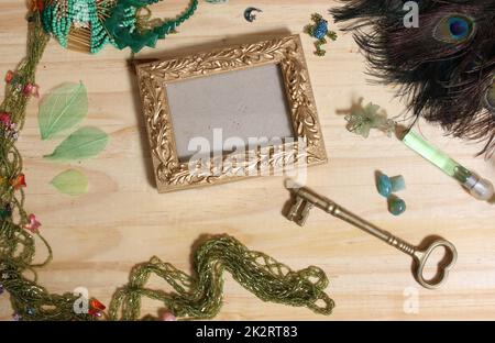 Green Jewelry and Peacock Feathers With Gold Picture Frame on Wooden ...