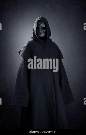 Grim reaper over dark misty background Stock Photo - Alamy