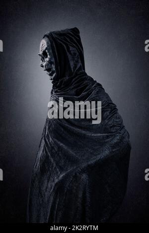 Grim reaper over dark misty background Stock Photo - Alamy