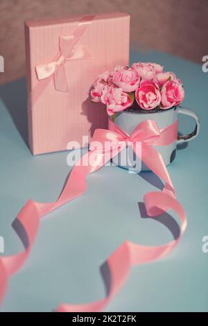 Bouquet of pink roses and gift box on a concrete background. Valentine ...