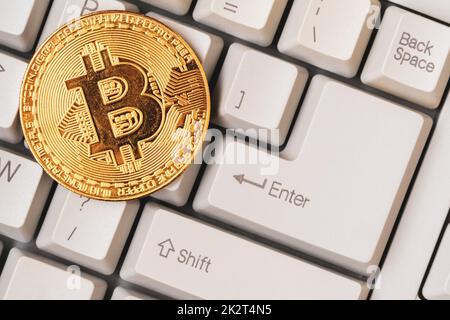 Bitcoin token coin on a computer keyboard Stock Photo - Alamy