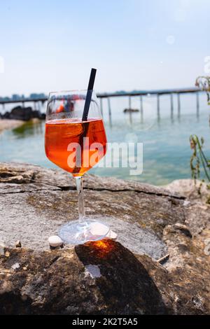 Summer beach with delicious Aperol Spritz cocktail, palm trees and ...
