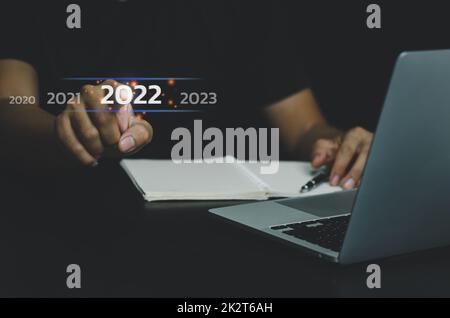 Businessman hand touching 2022 year number on virtual screen concept ...