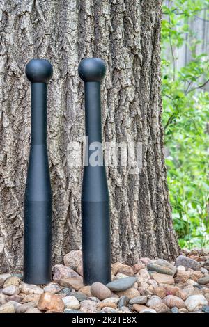 pair of heavy steel clubs in backyard Stock Photo - Alamy