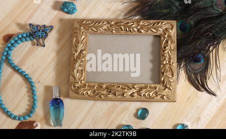 Blue Jewelry and Peacock Feathers With Gold Picture Frame on Wood ...