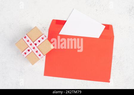 Gift box, envelope and paper hearts on beige background Stock Photo - Alamy