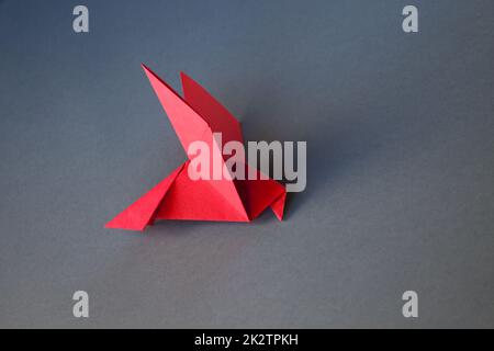Red paper dove origami isolated on a grey background Stock Photo - Alamy