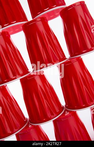 A vertical of a cup pyramid made of red disposable plastic cups against ...