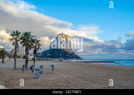 View of the beach of Calpe at sunset, with the Peñon de Ifach in the ...