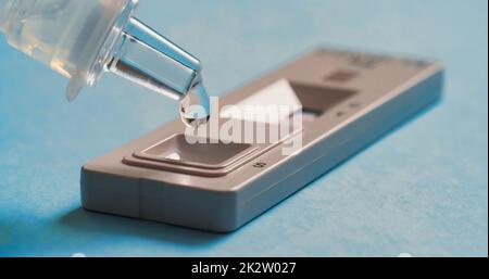 Adding drops to the details of the Covid-19 Antigen Test Stock Photo ...