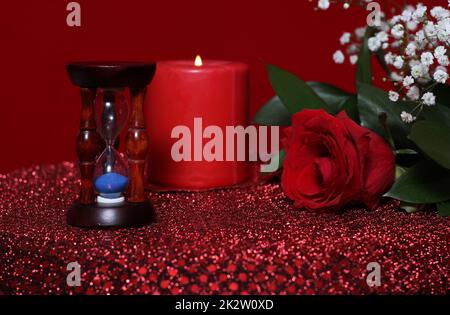 Red Candle and Rose on Red Velvet Background With Hourglass Stock Photo ...