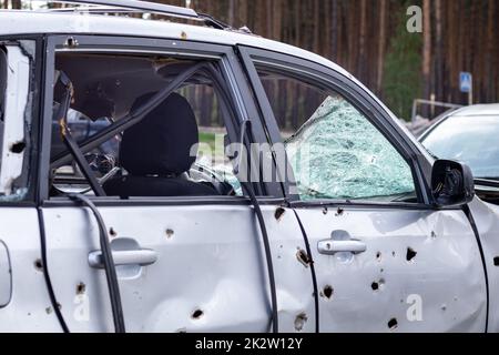 Car riddled with bullets. War of Russia against Ukraine. A car of ...