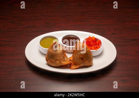 Indian cuisine - stuffed fried samosa pastrie Stock Photo - Alamy