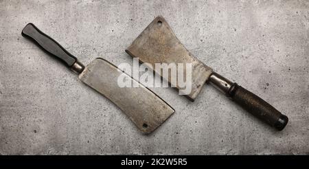 Two vintage butcher meat cleavers on table Stock Photo - Alamy
