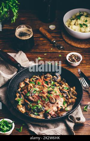 Fried pork neck steak with different mushrooms cast iron pan Stock ...