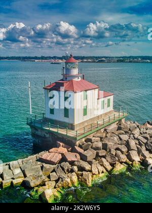 A drone shot of the Ashtabula Harbor Light building under a cloudy sky ...