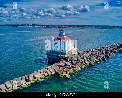 A drone shot of the Ashtabula Harbor Light building under a cloudy sky ...