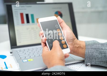 Asian accountant working and analyzing financial reports project ...
