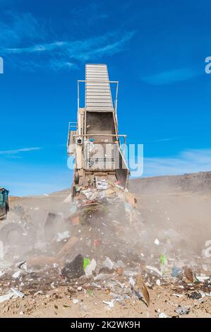 A semitrailer trailer is in a landfill tipper waiting to be dumped out ...