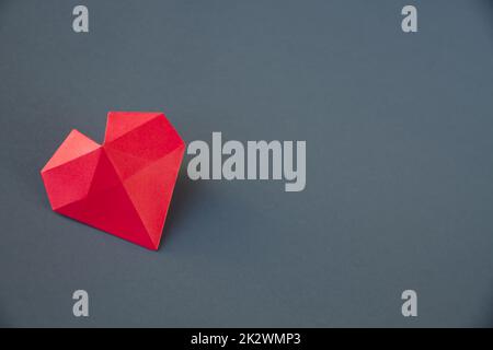 Red paper heart origami isolated on a blank grey background. Valentines ...