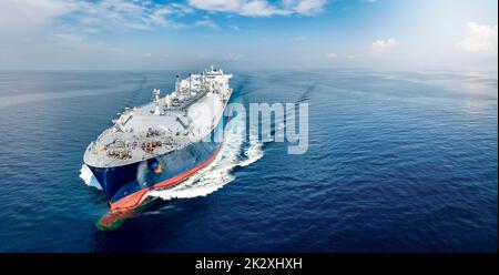 Front view of a big LNG tanker ship travelling over the calm, blue ...