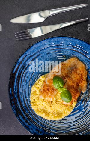 spicy fillet of white cod with couscous Stock Photo - Alamy