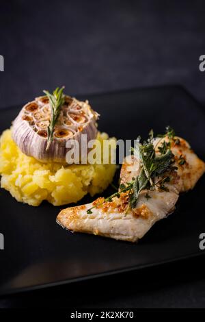 cod fillet with couscous and roasted garlic Stock Photo - Alamy