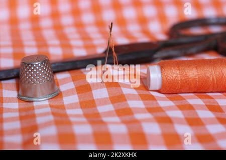 Orange and White Checkered Fabric With Thimble and Spool of Orange ...