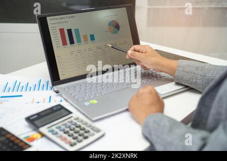 Asian accountant working and analyzing financial reports project ...