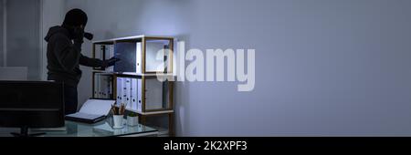 Thief Stealing Computer From Office At Night Stock Photo - Alamy