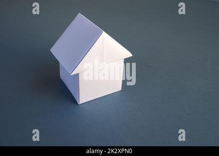 White paper house origami isolated on a blank grey background Stock ...