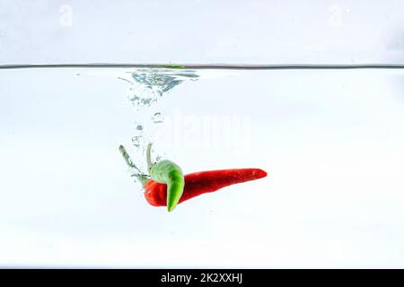 Red chilli, water splashes, solated on a white background Stock Photo ...