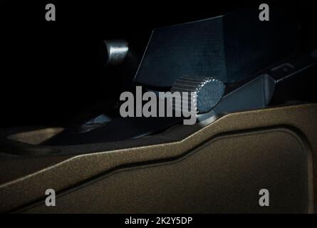 Safety engaged on a metallic copper finished bolt action rifle in the ...