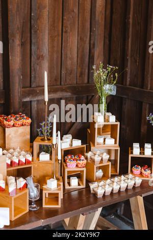 Candy bar. Festively decorated buffet table for guests. A stand with a ...