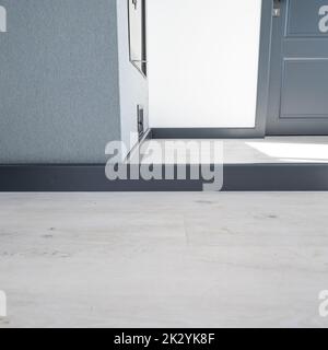 The plinth is dark gray to match the color of the door, mounting the ...