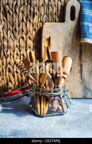 Glass jar with variety of wooden spoons on kitchen table Stock Photo ...