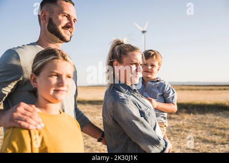 Confident family looking at distance Stock Photo - Alamy