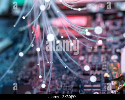 Fiber optic cables against computer mother board Stock Photo - Alamy
