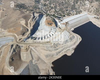 An aerial view of the labyrinth weir, emergency spillway, and service ...