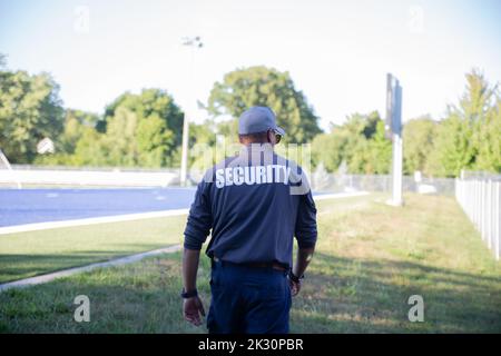 Security guard patrolling soccer stadium Stock Photo - Alamy