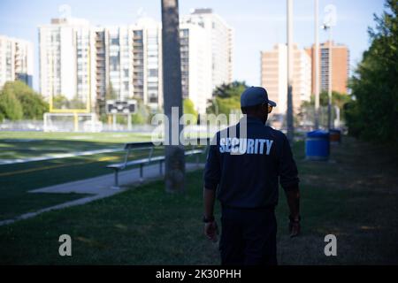 Security guard patrolling soccer stadium Stock Photo - Alamy