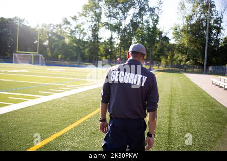 Security guard patrolling soccer stadium Stock Photo - Alamy