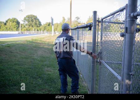 Security guard patrolling soccer stadium Stock Photo - Alamy
